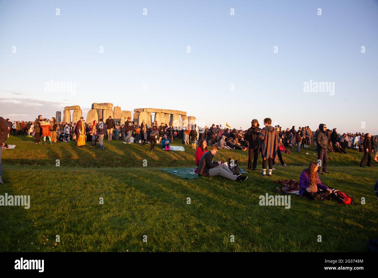 Revellers celebrating the summer solstice amongst the ancient stones of ...
