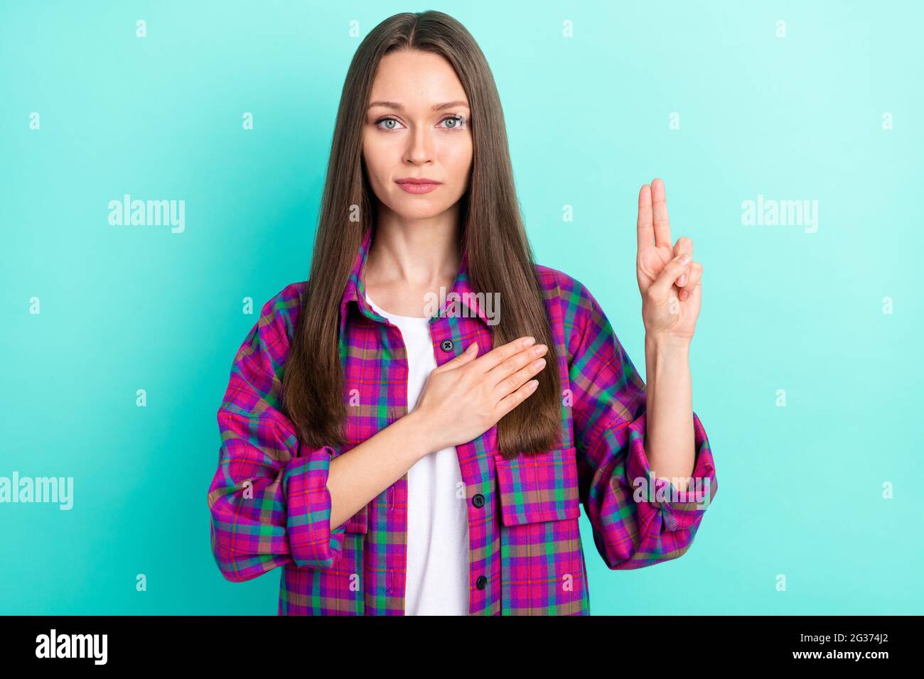 Portrait of attractive serious girl touching heart saying oath showing ...