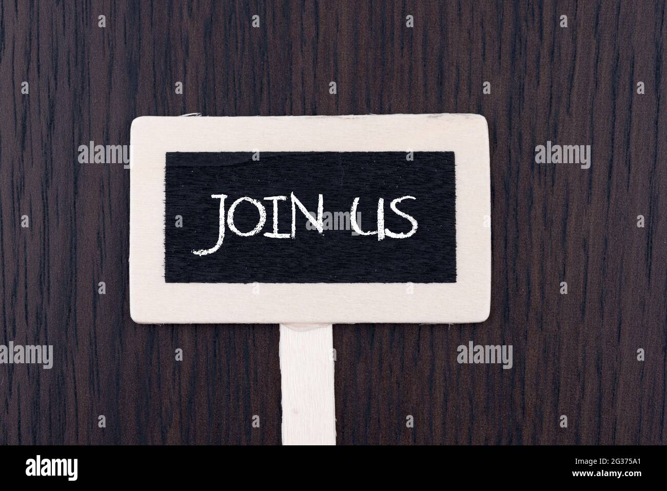 Top view of a "join us" signboard on dark wooden background Stock Photo ...