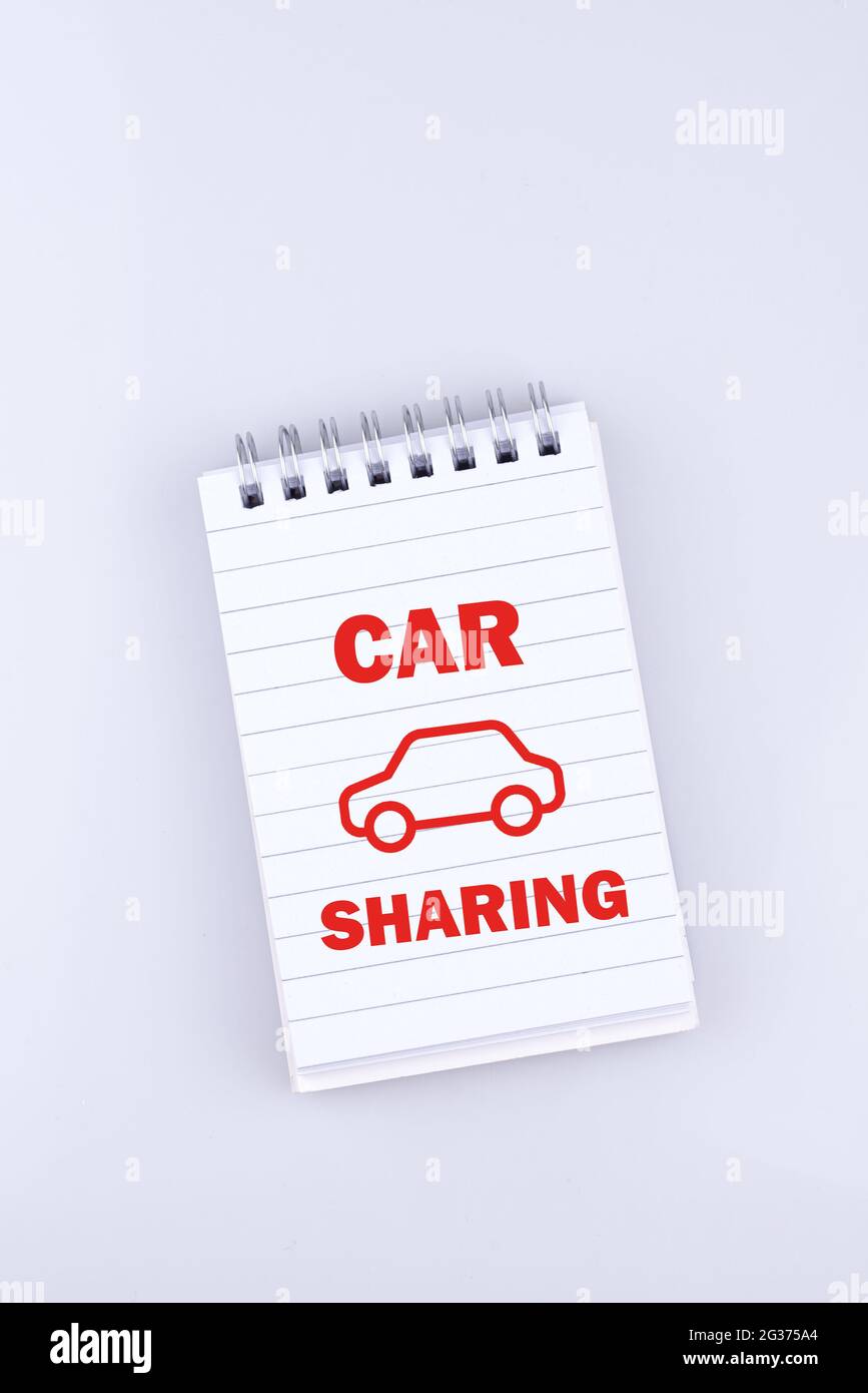 Vertical shot of a notepad with the text "car sharing" isolated on ...