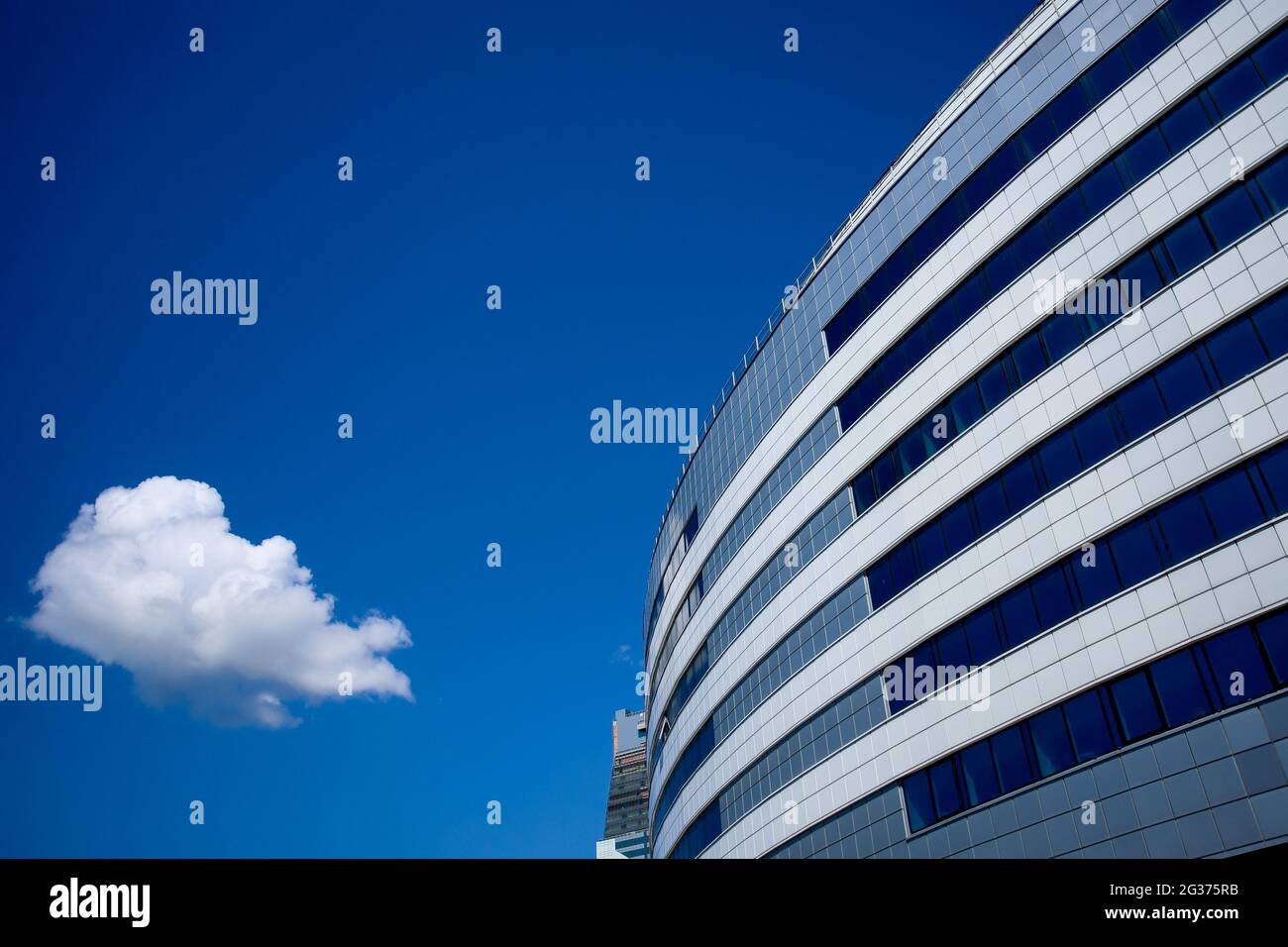 The new building of the sports complex against the blue sky. Glass ...