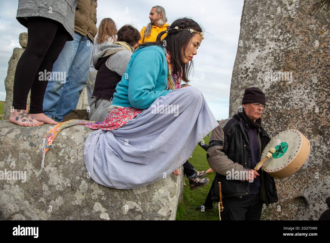 Revellers celebrating the summer solstice amongst the ancient stones of ...