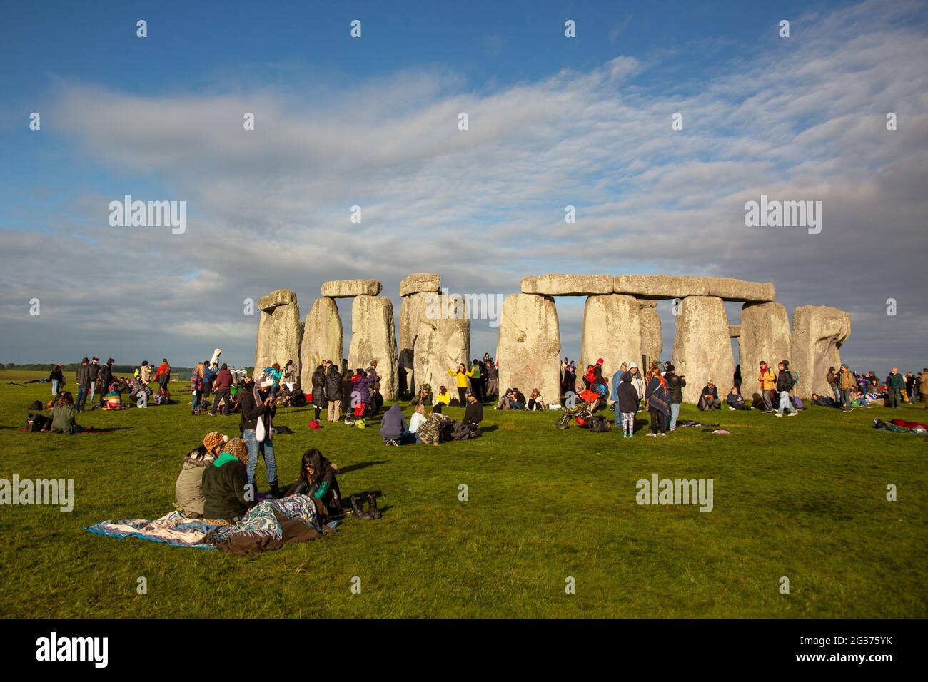 Revellers celebrating the summer solstice amongst the ancient stones of ...