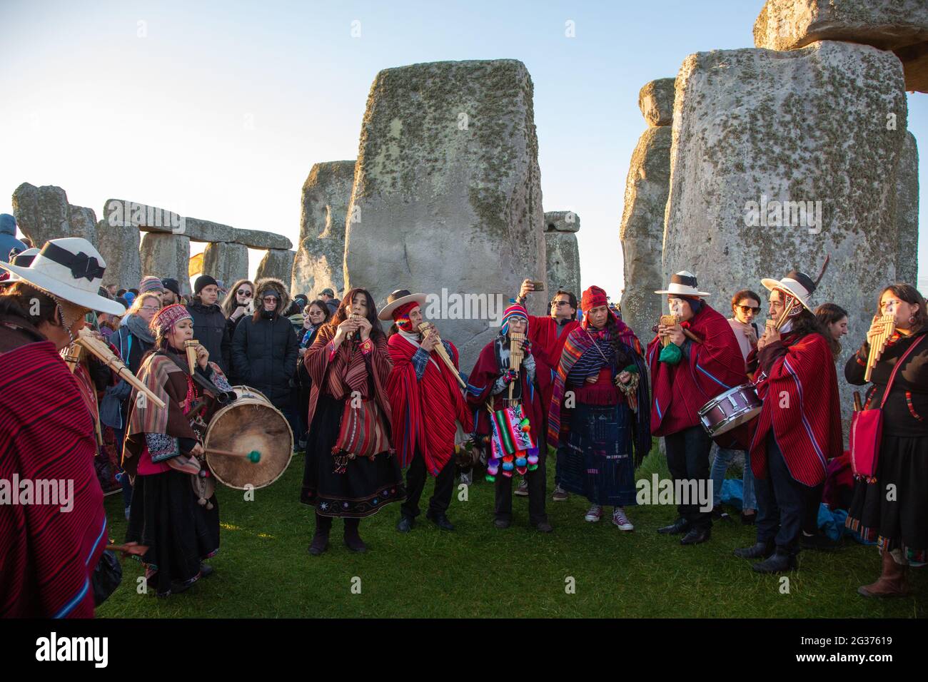 Revellers celebrating the summer solstice amongst the ancient stones of ...