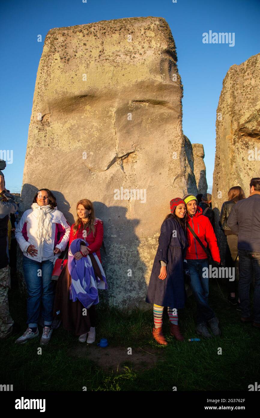 Revellers celebrating the summer solstice amongst the ancient stones of ...