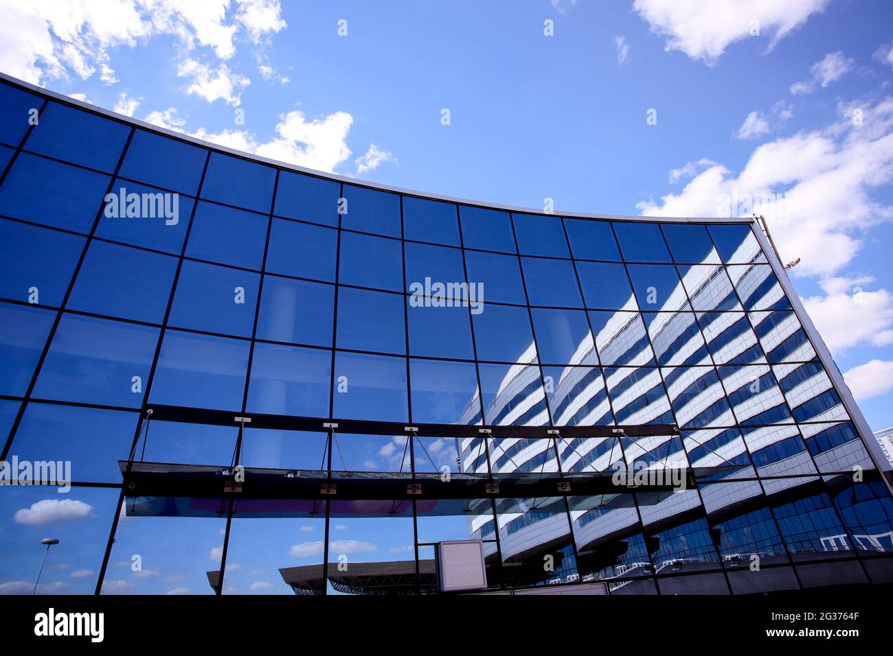 The new building of the sports complex against the blue sky. Glass ...