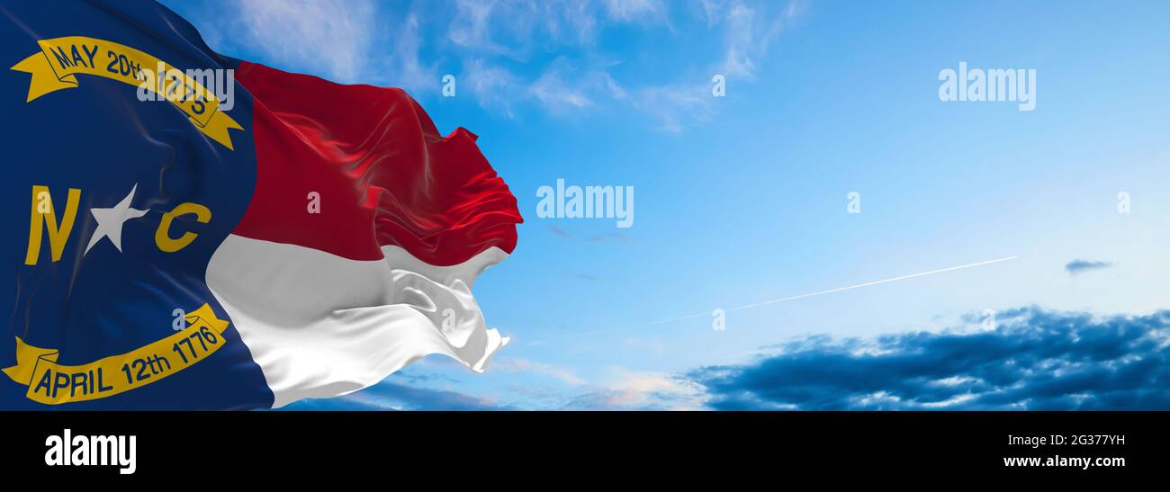 flag of North Carolina at cloudy sky background on sunset. Patriotic ...