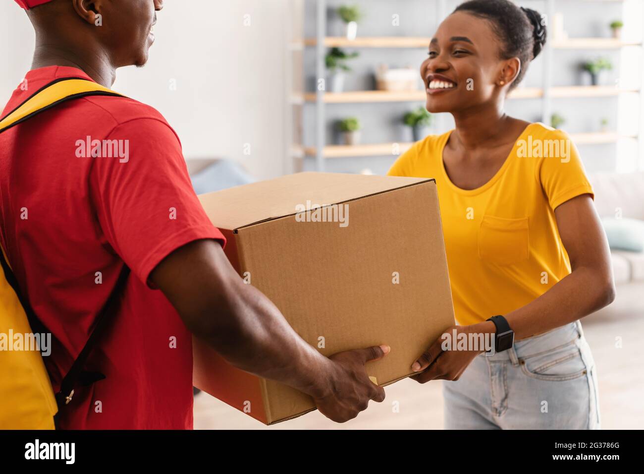 Happy African American Woman Receiving Box From Courier At Home Stock ...