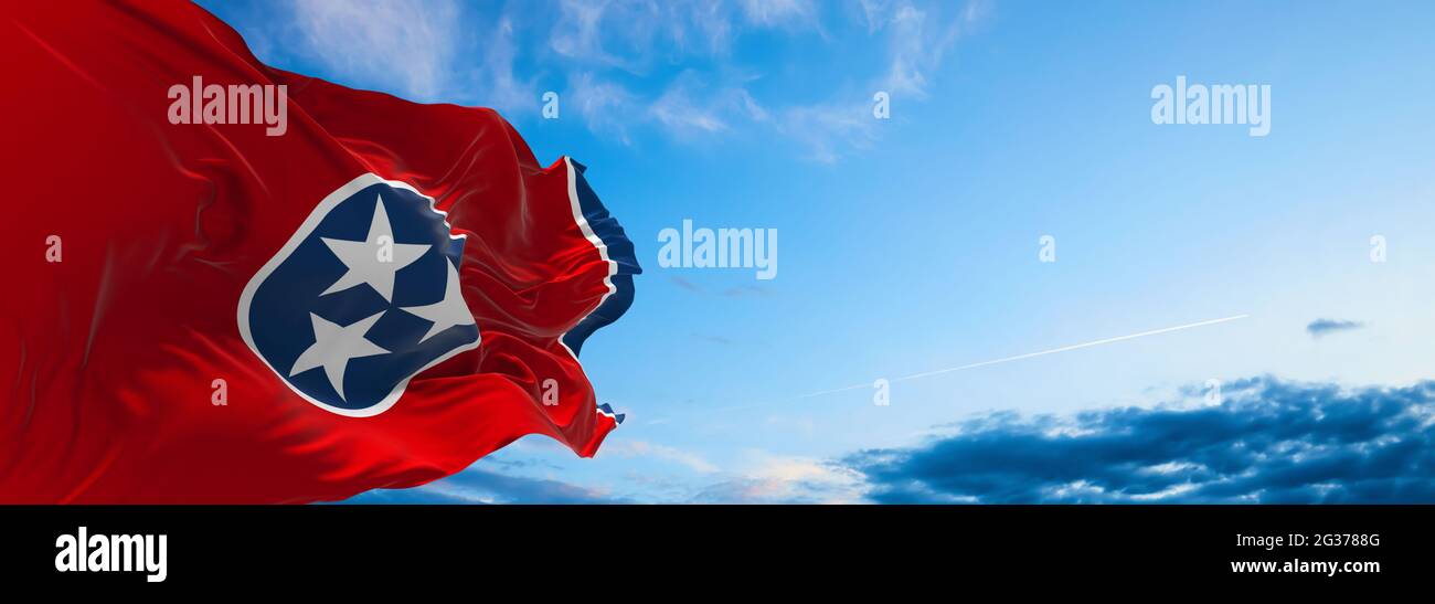 flag of Tennessee at cloudy sky background on sunset. Patriotic concept ...