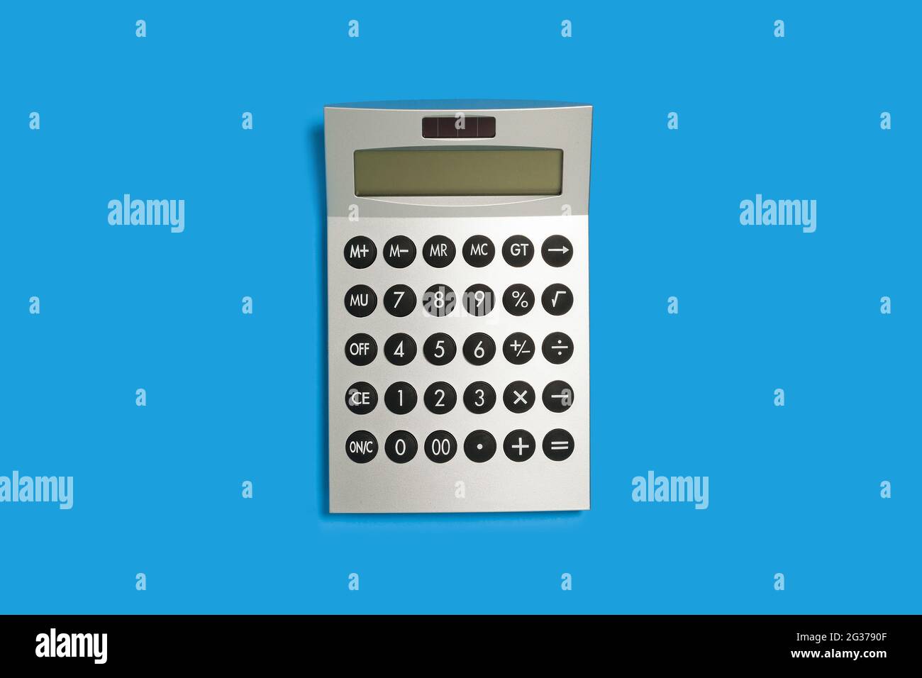 grey plastic office calculator on a blue surface Stock Photo - Alamy