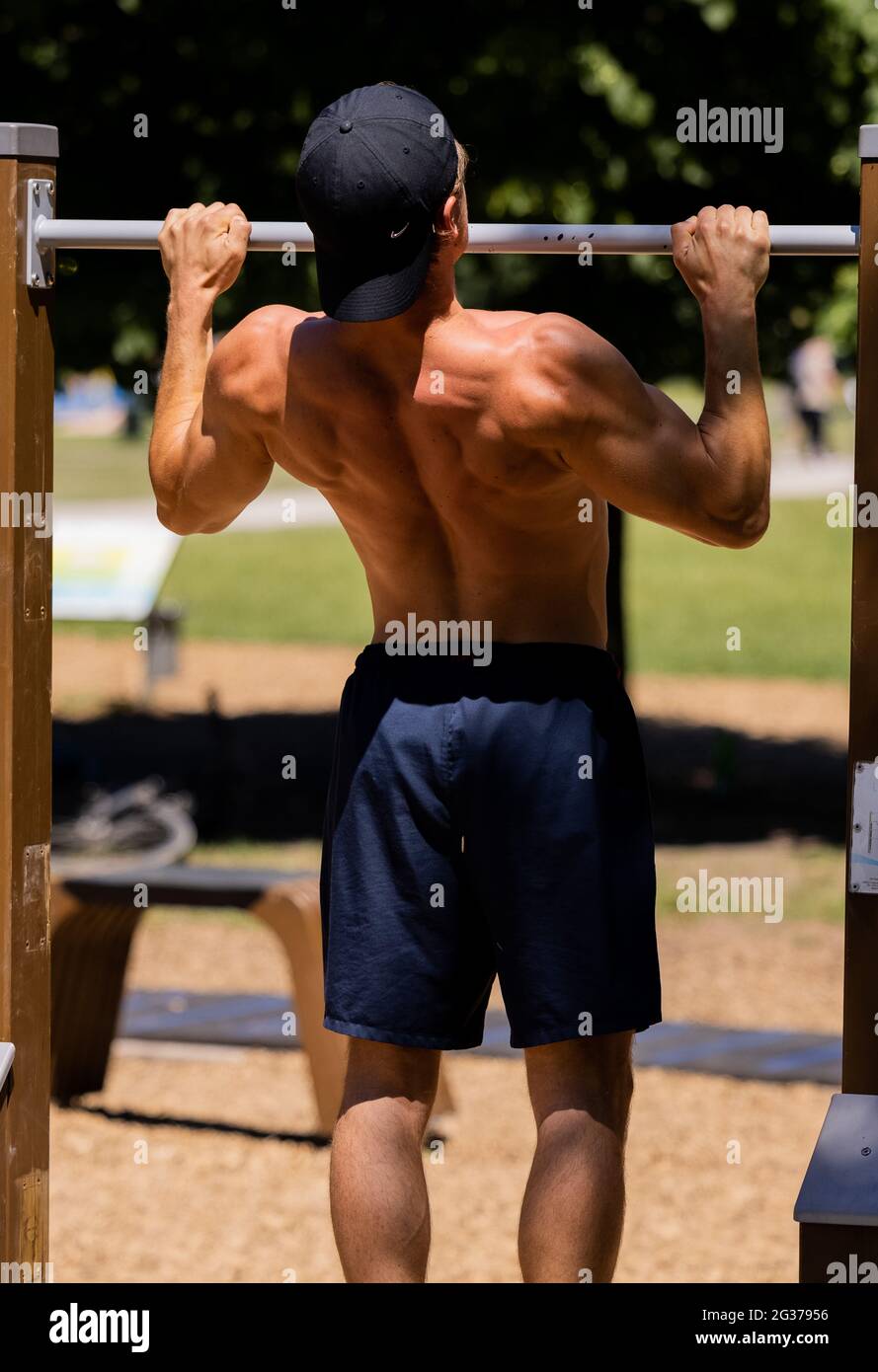 Cologne, Germany. 14th June, 2021. An athlete does pull-ups at an ...
