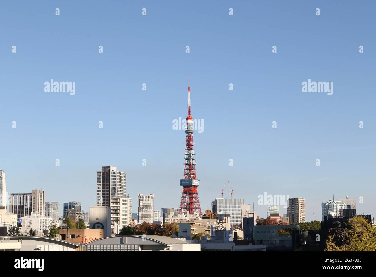 Cityscape with Tokyo Tower in front of blue sky, Tokyo, Japan Stock ...