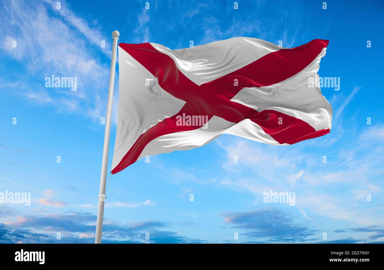 flag of Alabama at cloudy sky background on sunset. Patriotic concept ...