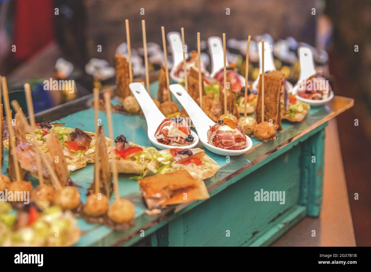 Assortment of tapas on a green wooden table for a ceremony Stock Photo ...