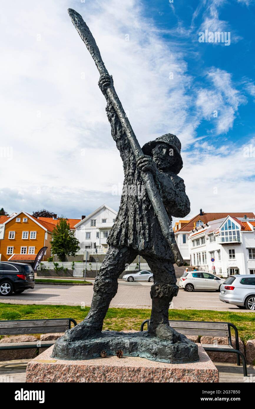 Statue in the harbour of the historic harbour town Grimstad, Norway ...