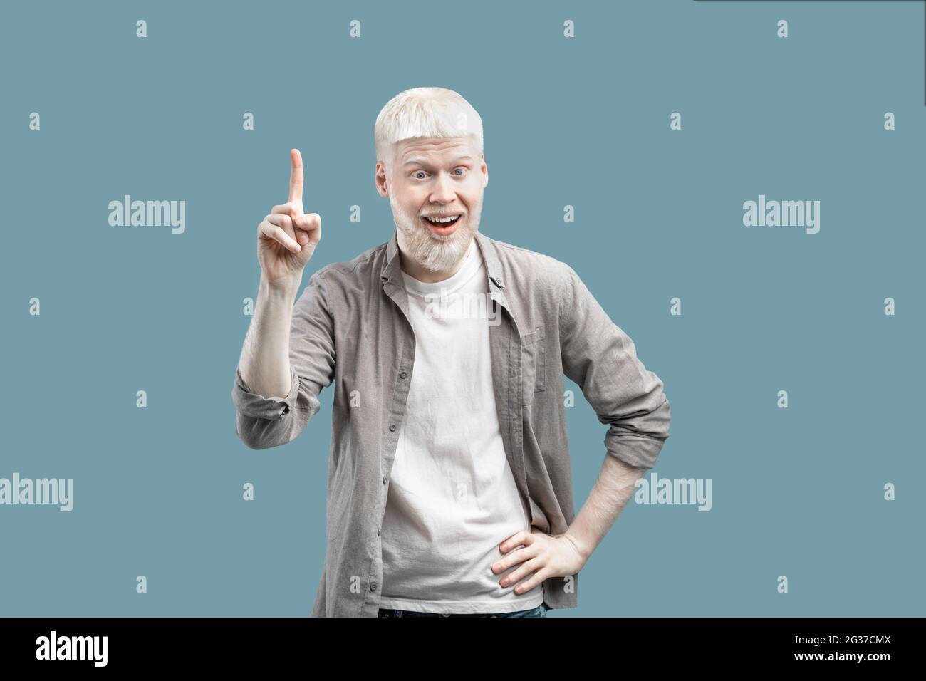 Wow, eureka. Young funny albino guy pointing finger up, got solution to ...