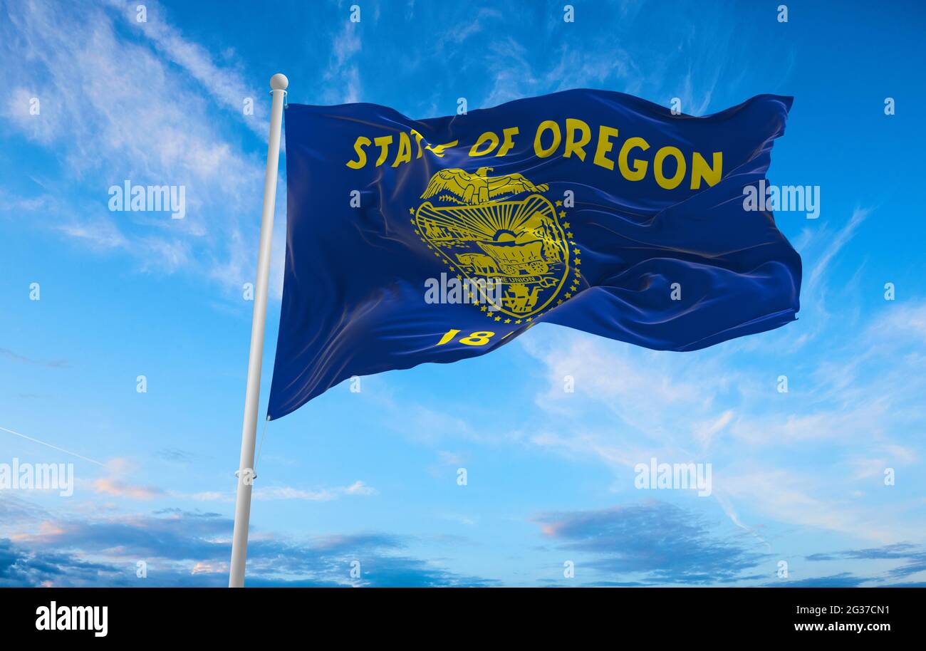 flag of Oregon at cloudy sky background on sunset. Patriotic concept ...