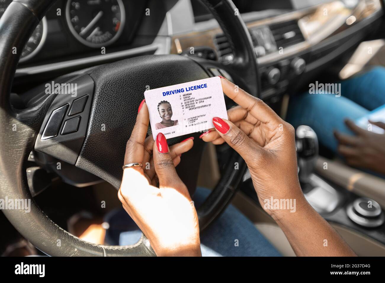 Closeup of driving license in black lady hands Stock Photo - Alamy