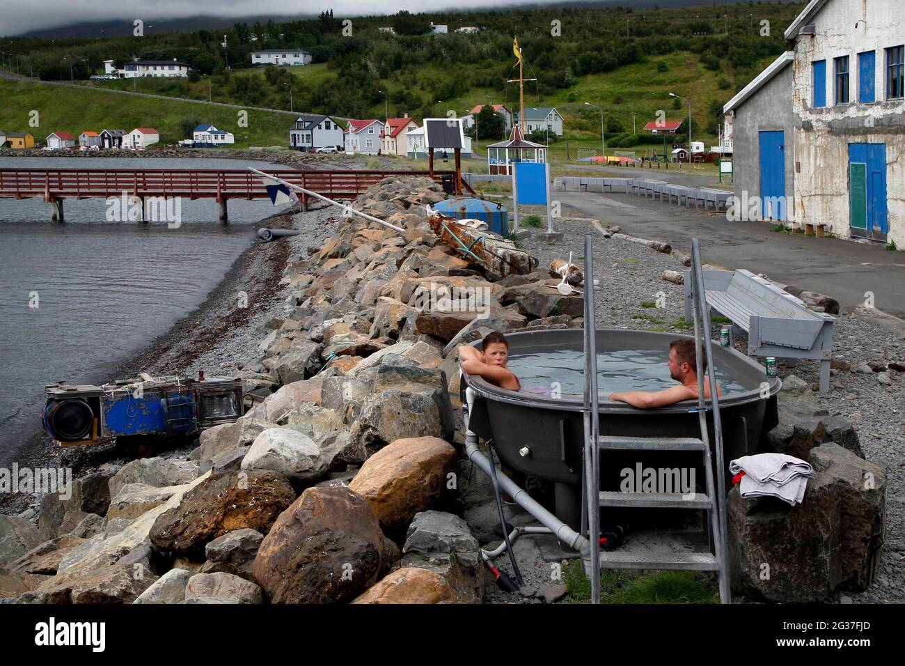 Hot pot, geothermal water pool with bathers, Halteyri, North Iceland ...
