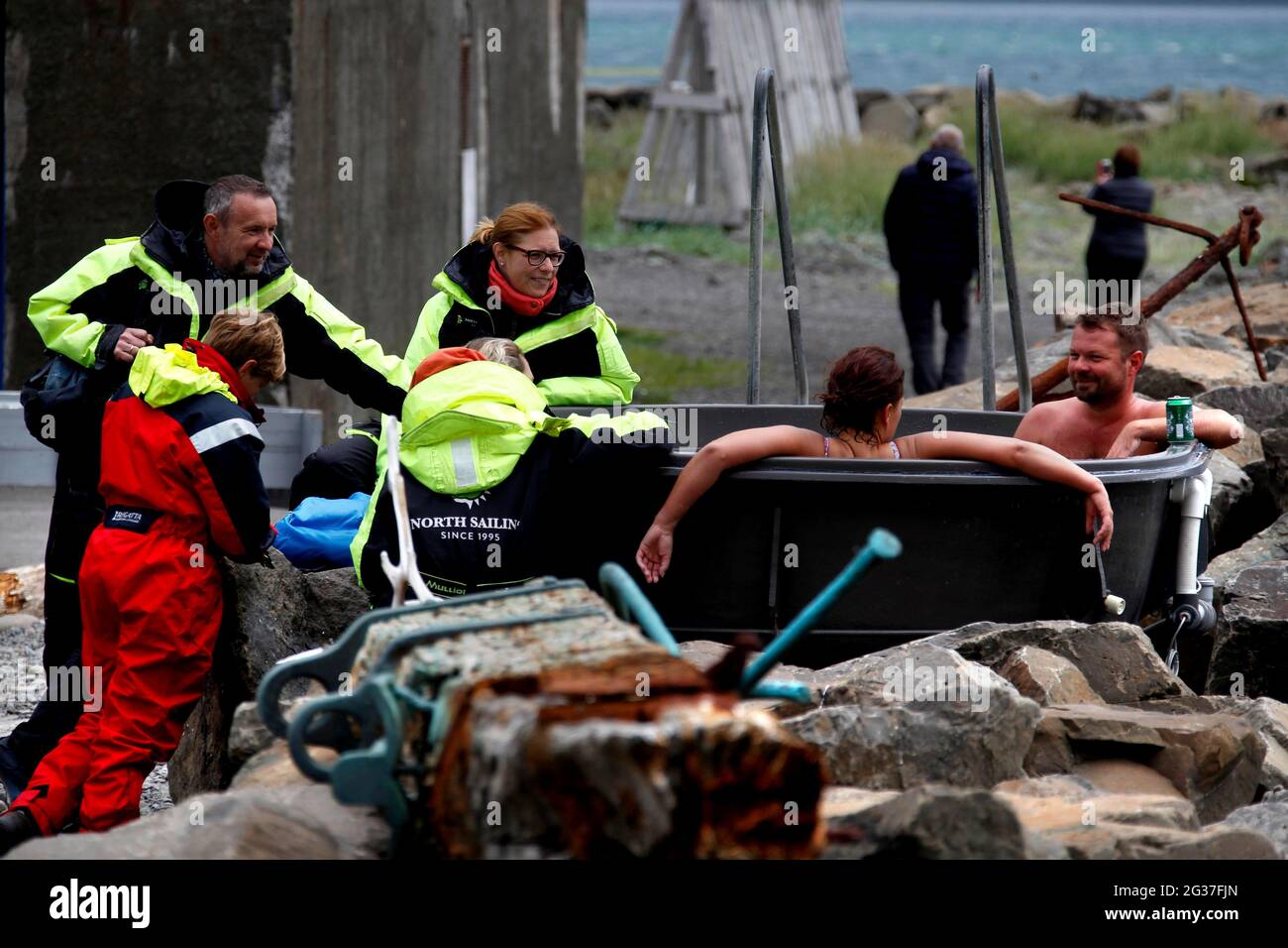 Hot pot, geothermal water pool with bathers, Halteyri, North Iceland ...
