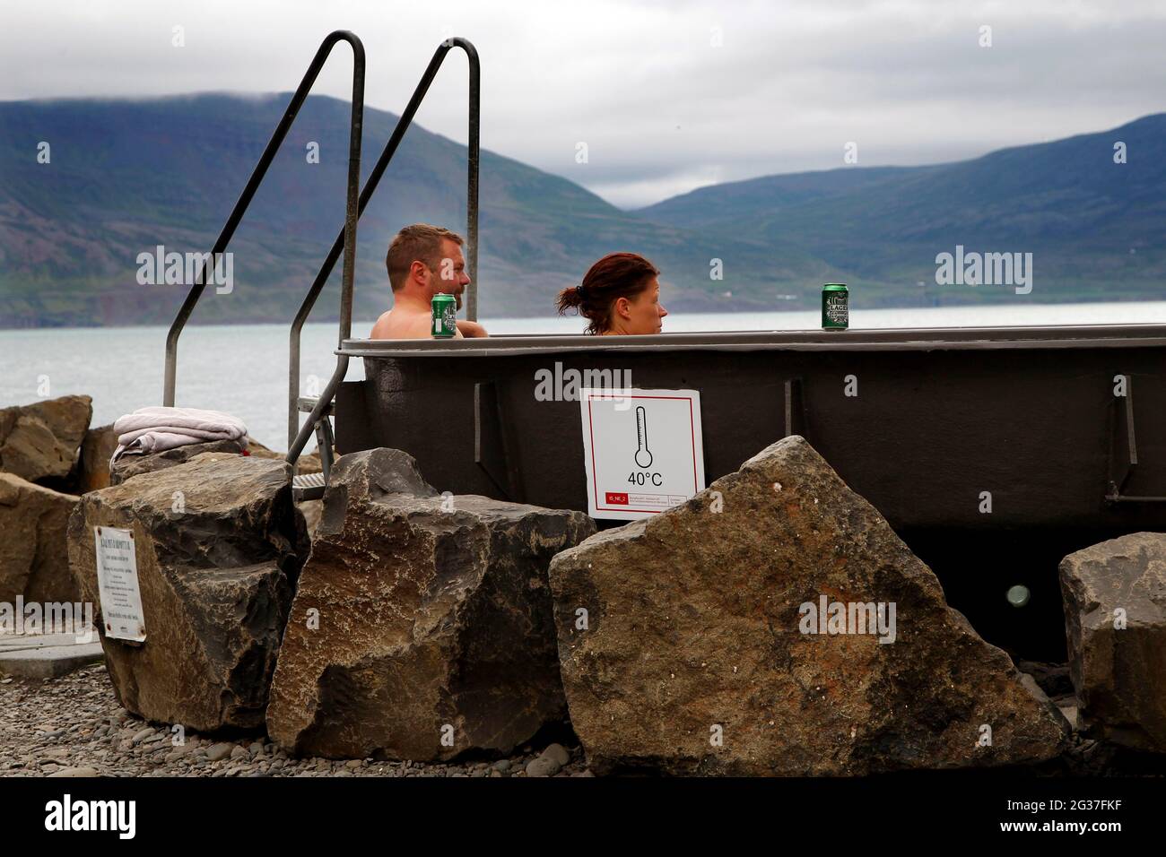 Hot pot, geothermal water pool with bathers, Halteyri, North Iceland ...
