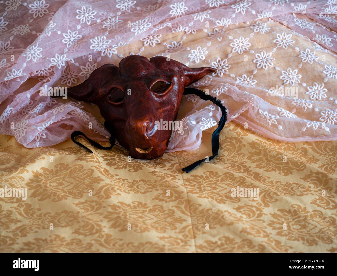 Dark bull mask for a parade on bed Stock Photo - Alamy