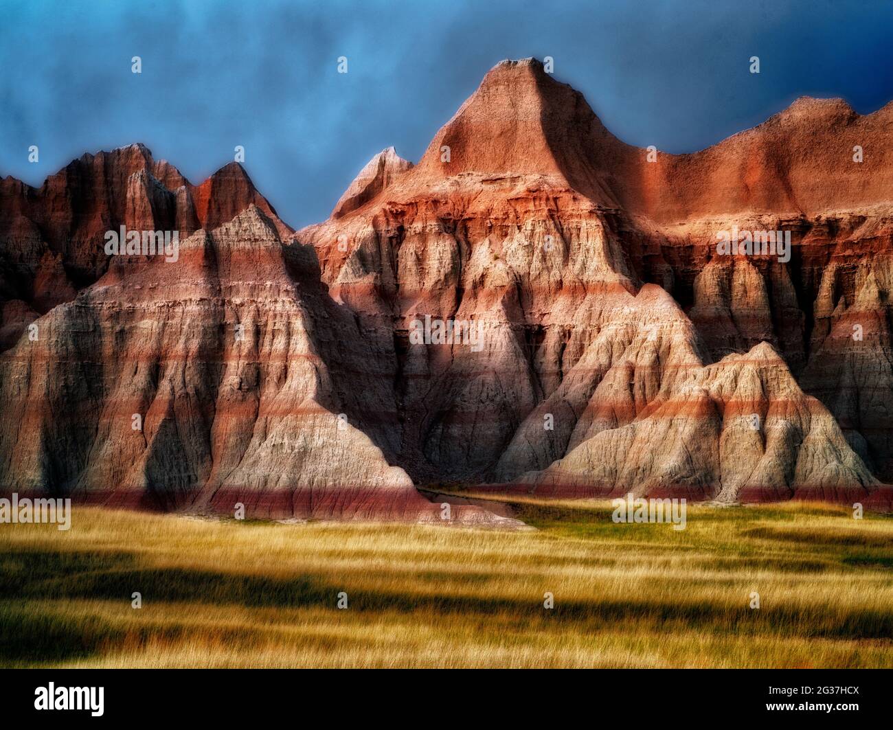 Grass meadow and colorful rocks. Badlands National Park, South Dakota ...
