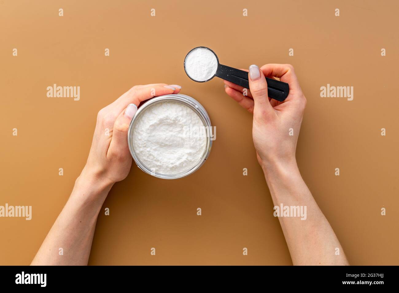Hands holding scoop with whey protein. Sport nutrition Stock Photo - Alamy