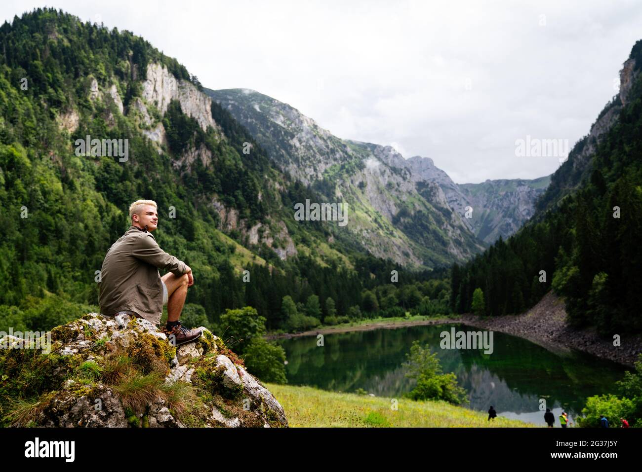 Adventure man hiking wilderness mountain with backpack Stock Photo - Alamy