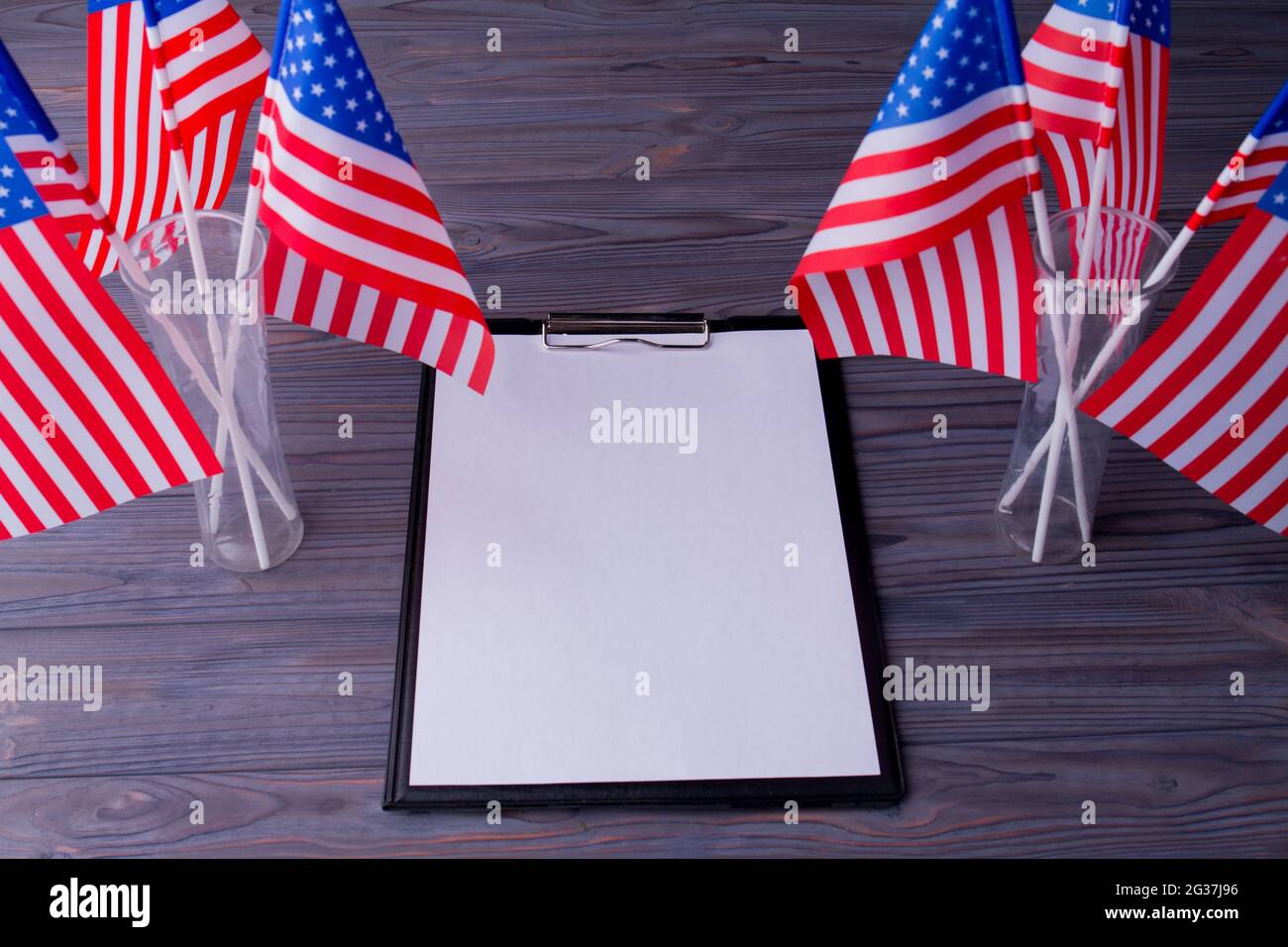 Composition of clipboard with white paper and american flags Stock ...