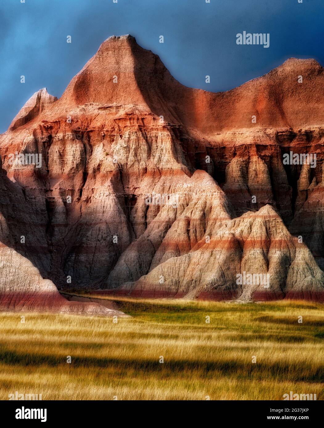 Grass meadow and colorful rocks. Badlands National Park, South Dakota ...