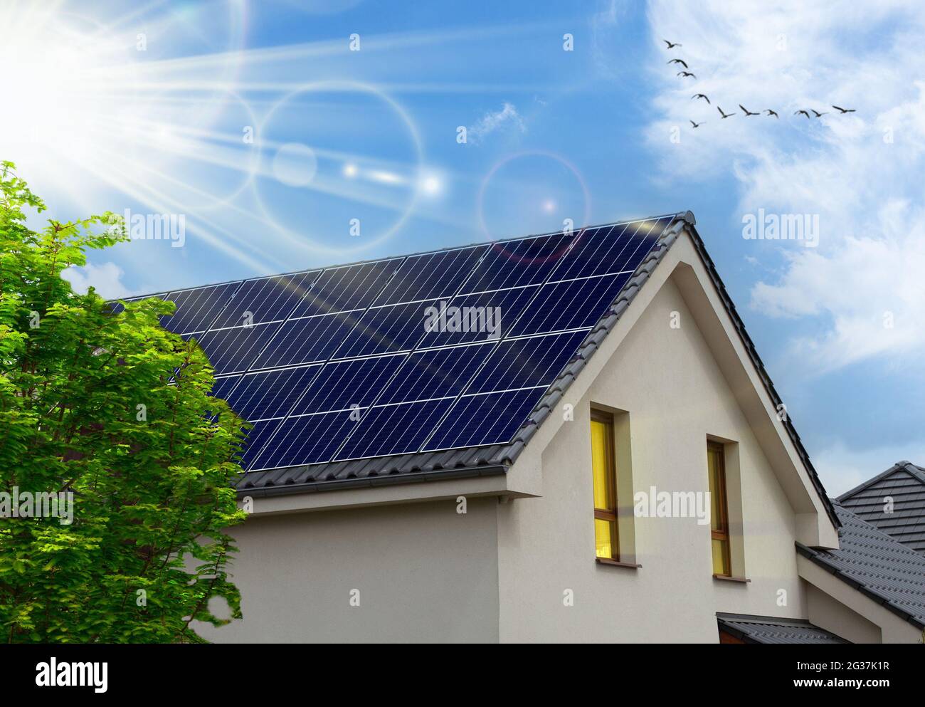 Solar panel on a roof reflecting the sun and the cloudless blue sky ...
