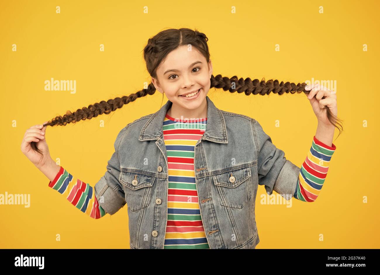 Happy little girl with braids wear denim clothes, kids clothes concept ...
