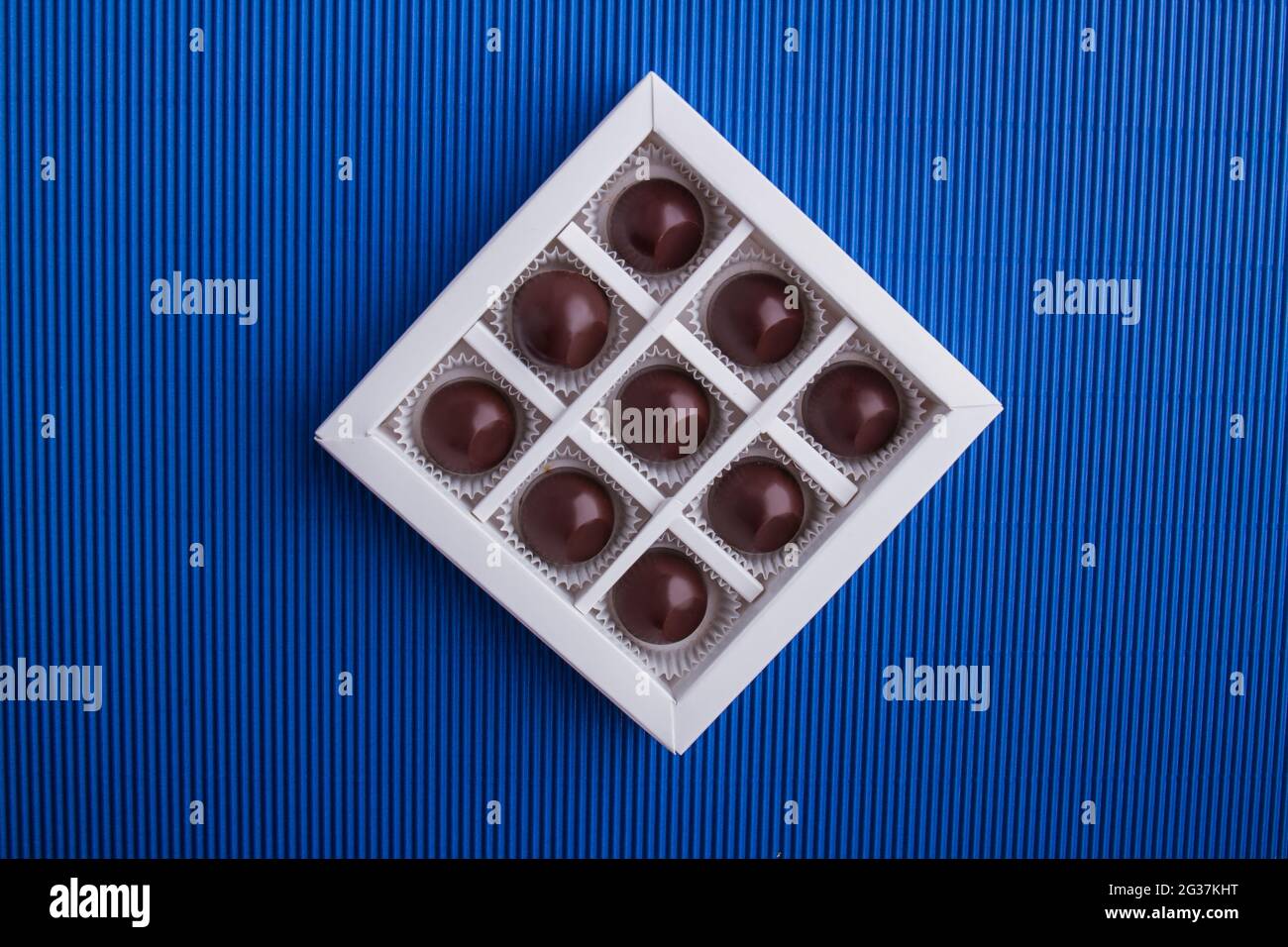 Box with brown chocolate candies top view Stock Photo - Alamy