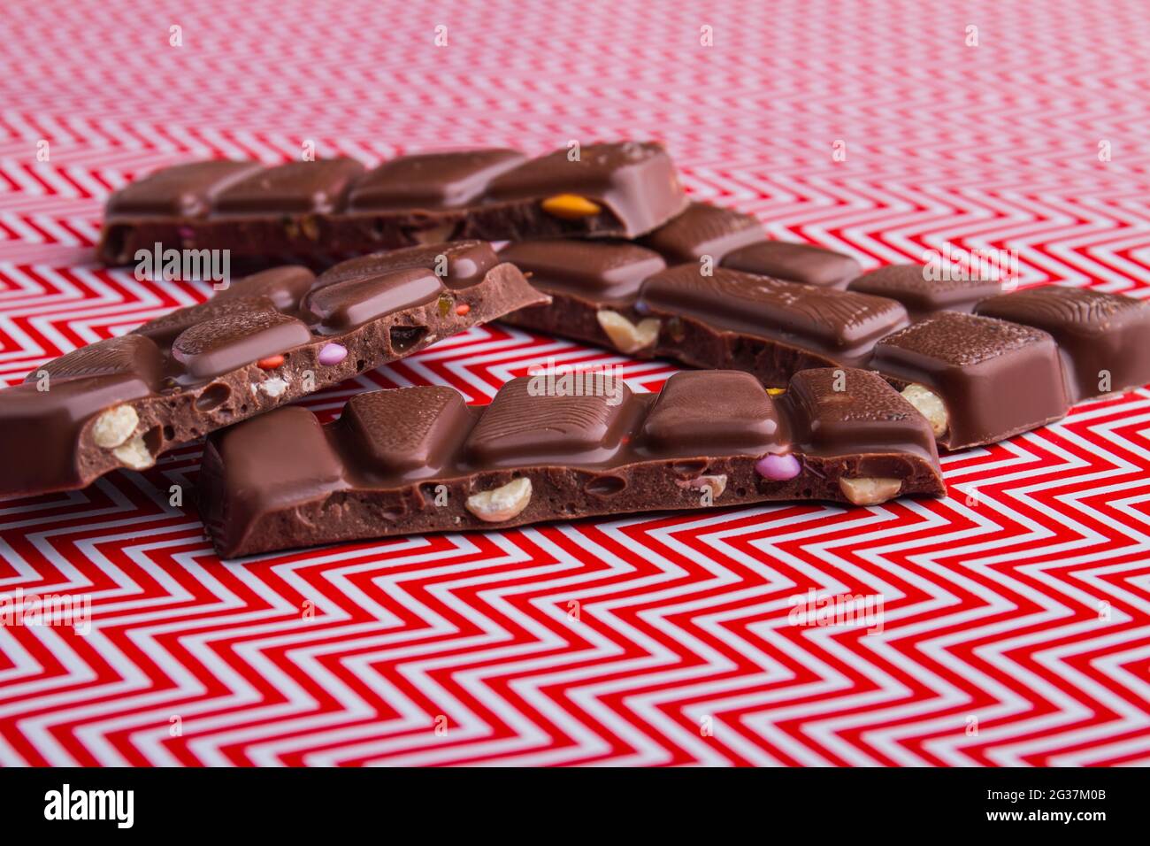 Close-up chocolate bar pieces with colorful candies Stock Photo - Alamy