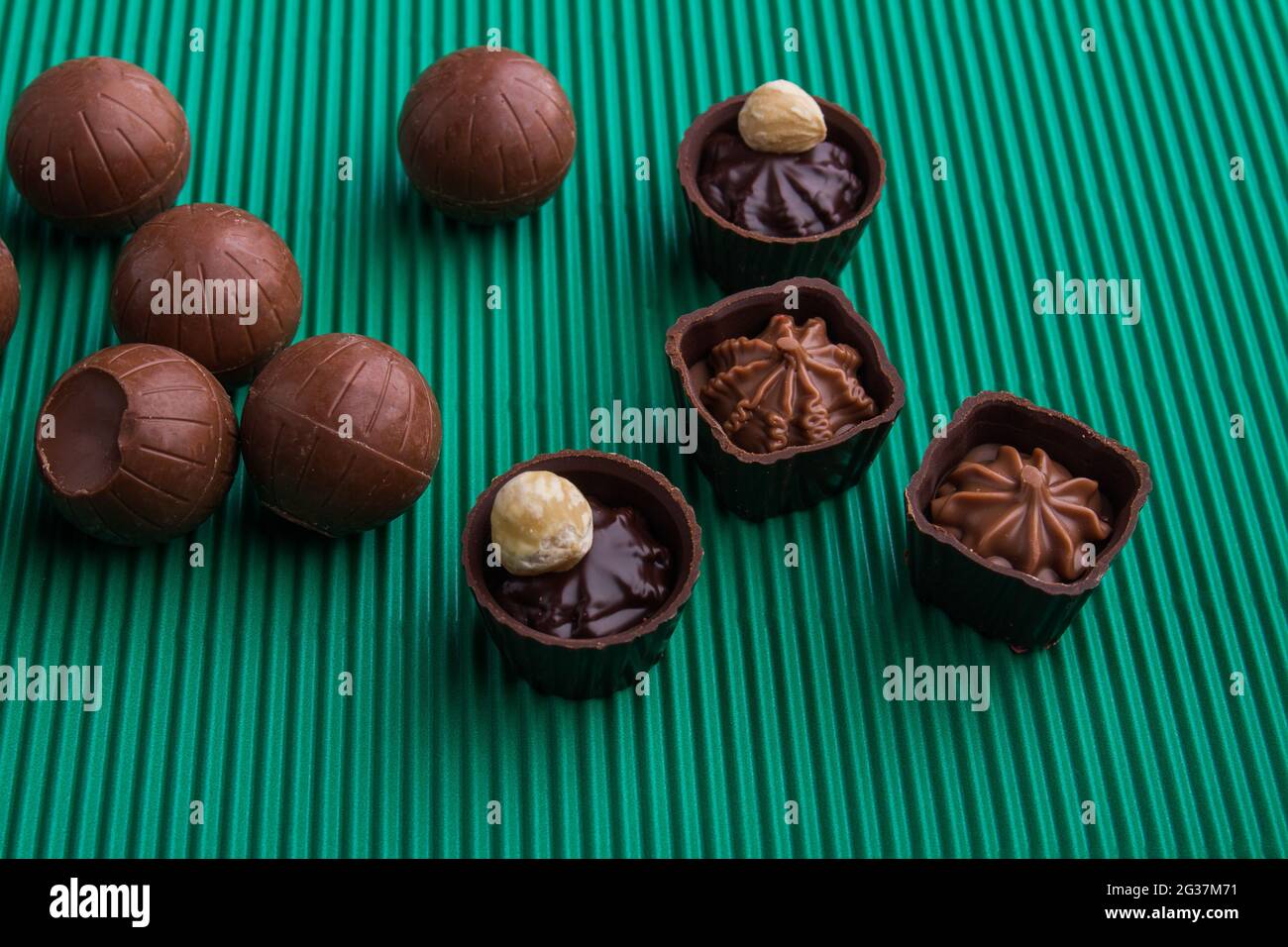 Assortment of various sweet chocolate candies with different fillings ...