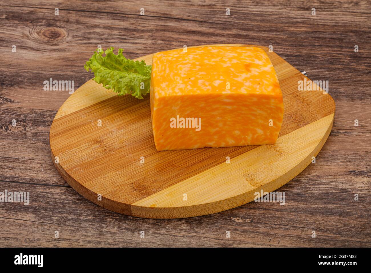 Dairy Marble cheese brick over board Stock Photo - Alamy