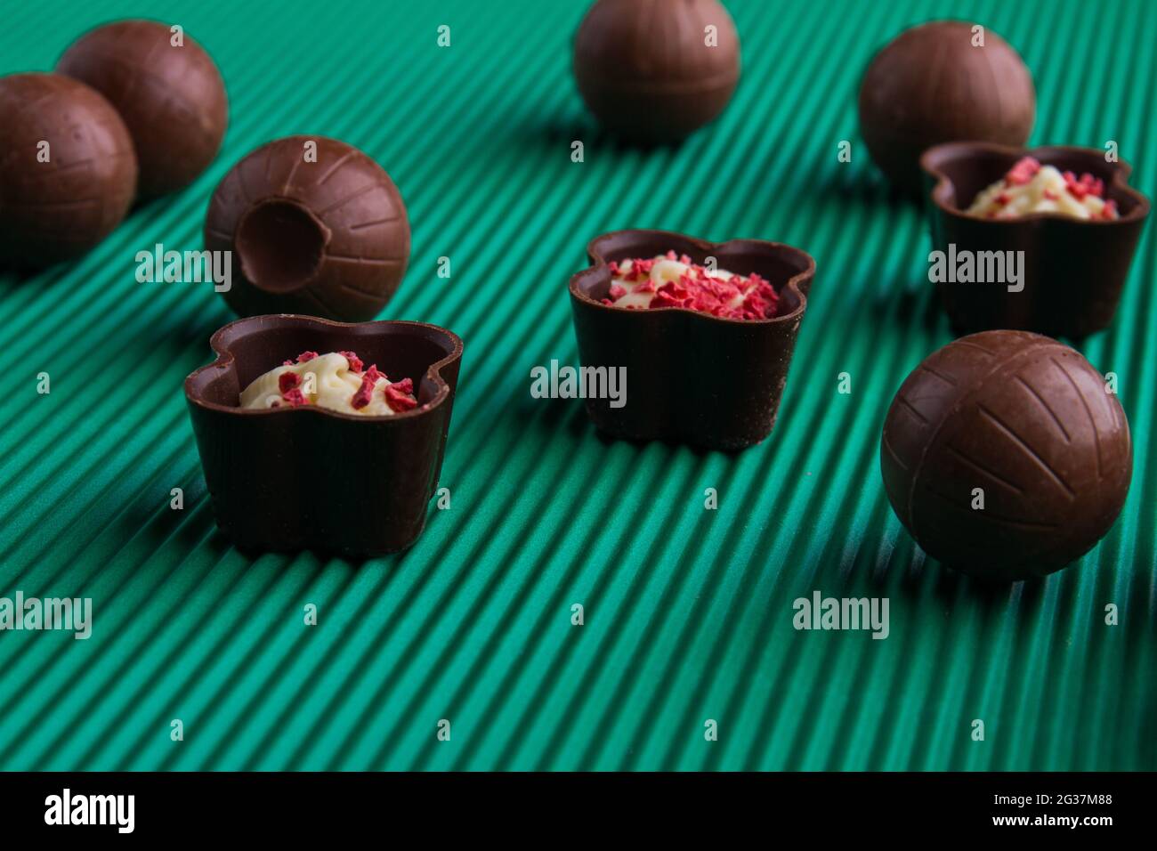 Close-up brown sweet chocolate candies on green background Stock Photo ...