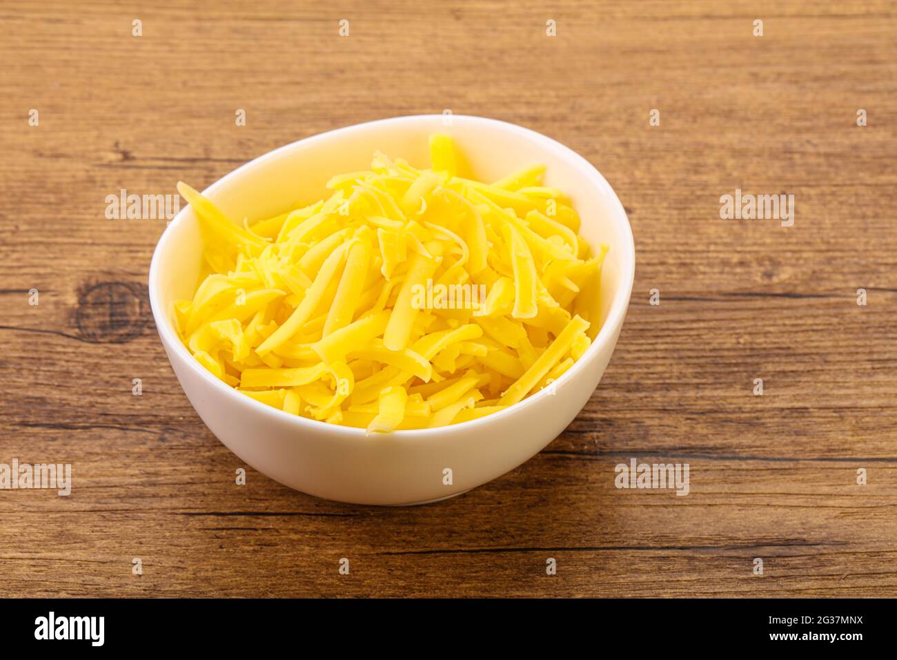 Shredded yellow cheese in the bowl for cooking Stock Photo - Alamy