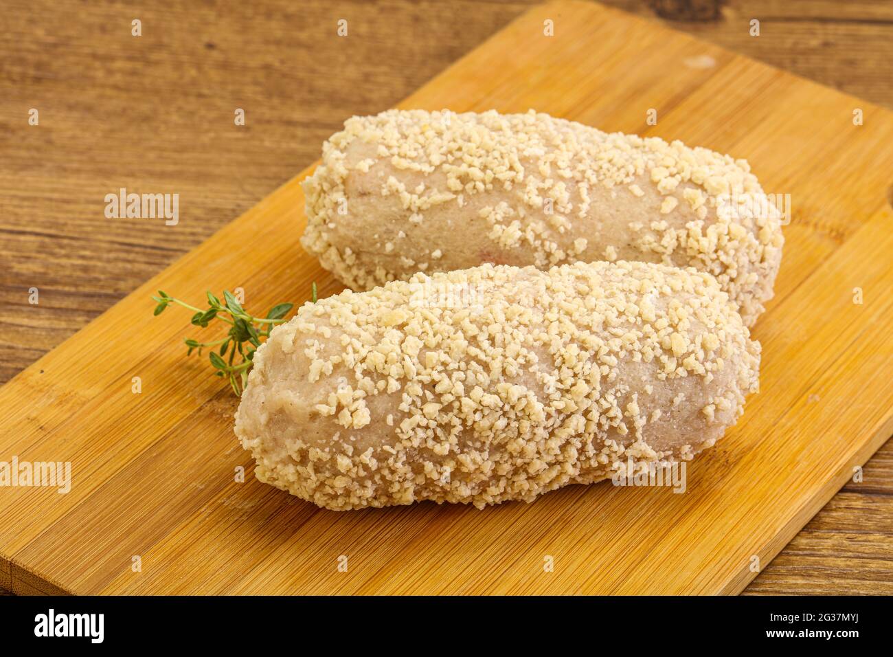 Raw breaded chicken cutlet for roast Stock Photo - Alamy