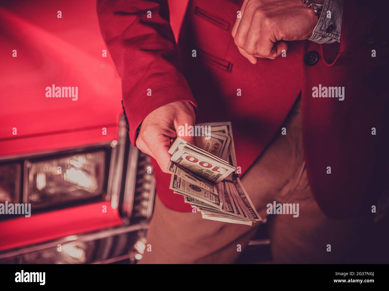 Caucasian Car Salesman with Cash Dollars in His Hands and Classic Red ...