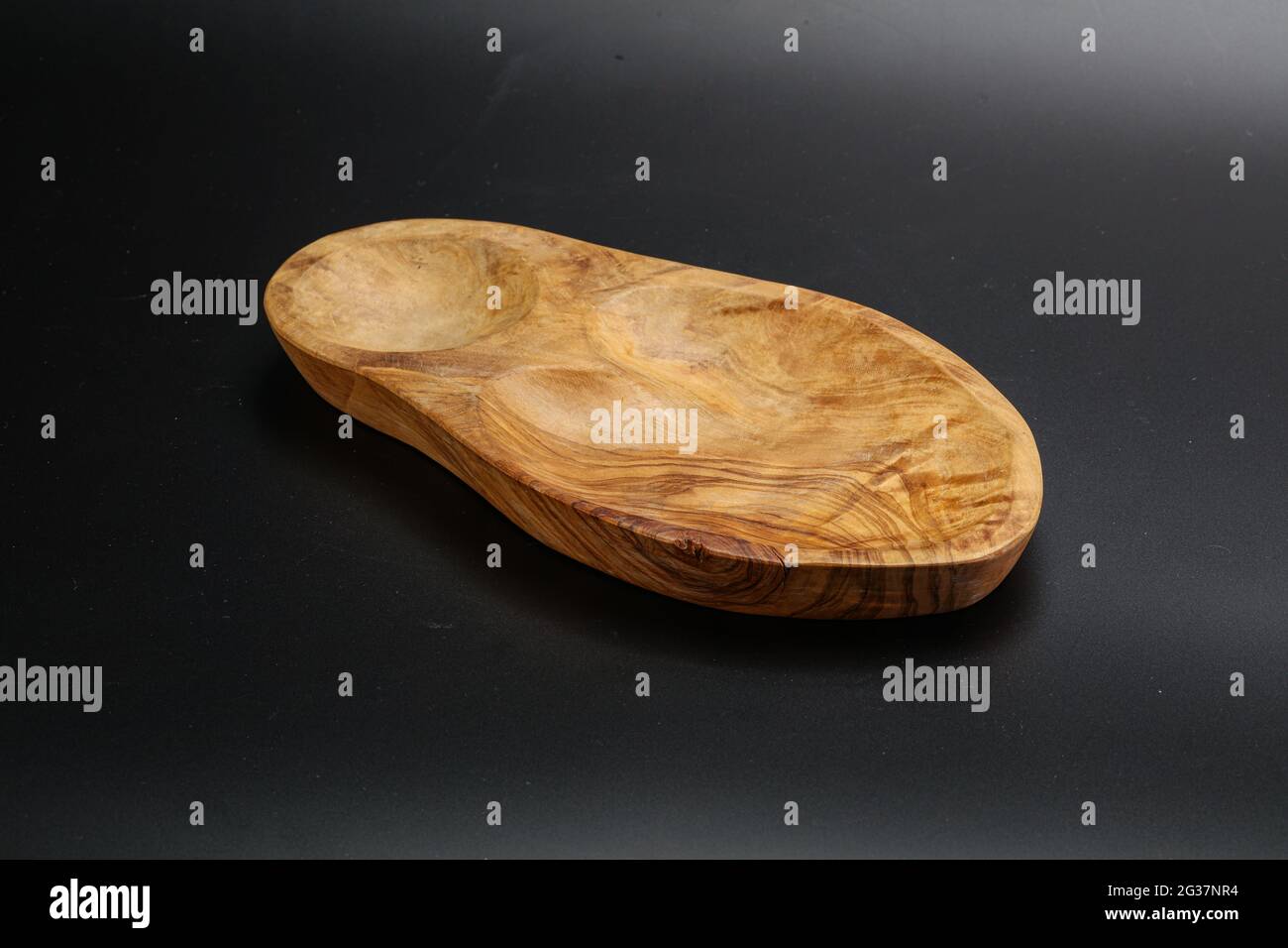 Olive tree board for kitchen over black background Stock Photo - Alamy
