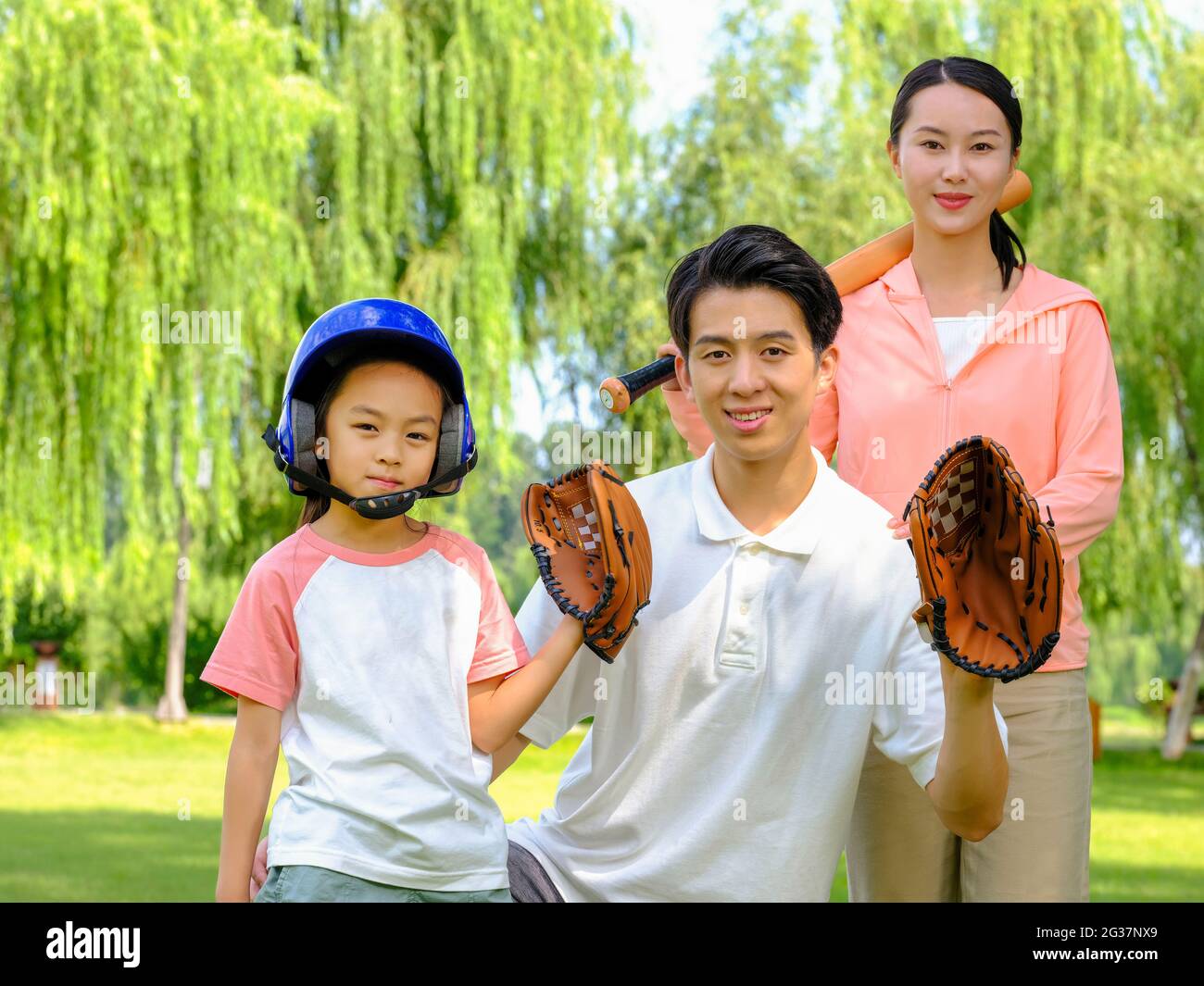 Happy family of three playing baseball in the park high quality photo ...