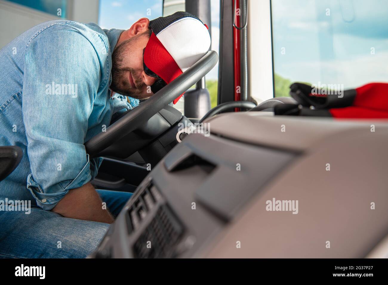 Caucasian Semi Truck Driver in His 30s Wearing Baseball Hat Sleeping on ...