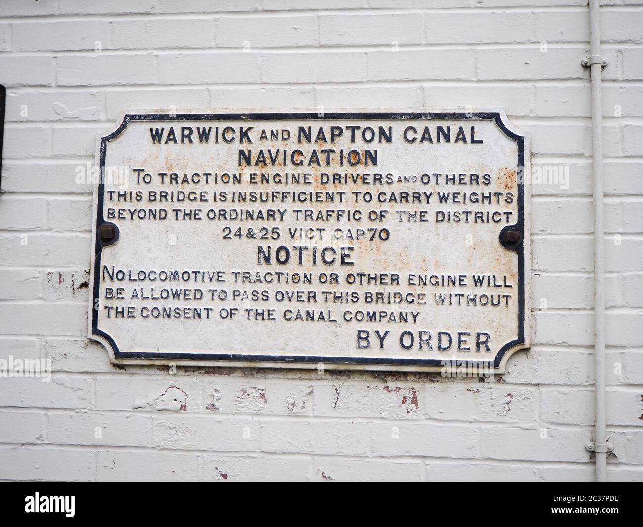A vintage warning sign seen on the wall of a canalside cottage Stock ...