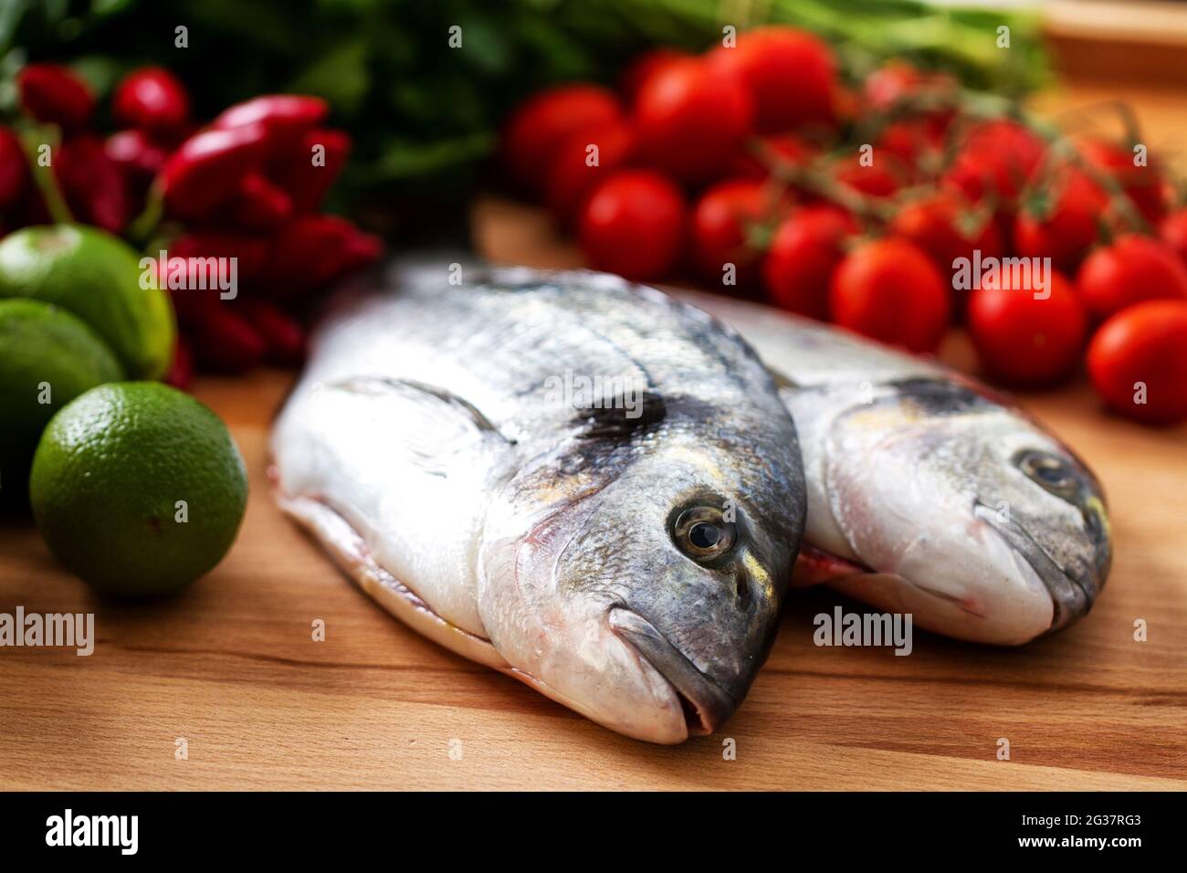 Raw Sea Bream Preparation with Herbs and Lemon Stock Photo - Alamy