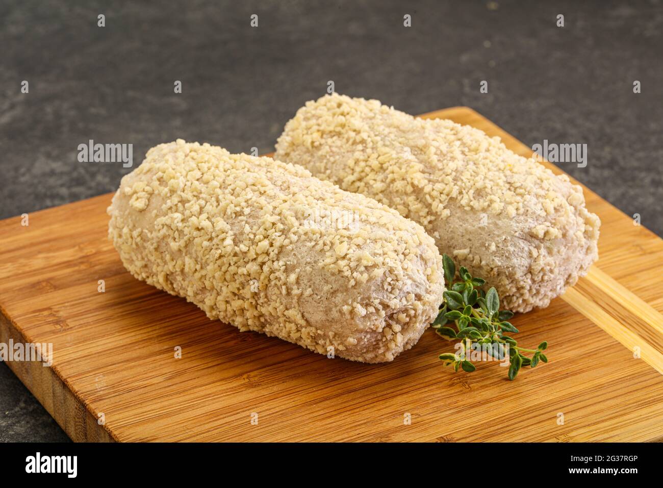 Raw breaded chicken cutlet for roast Stock Photo - Alamy