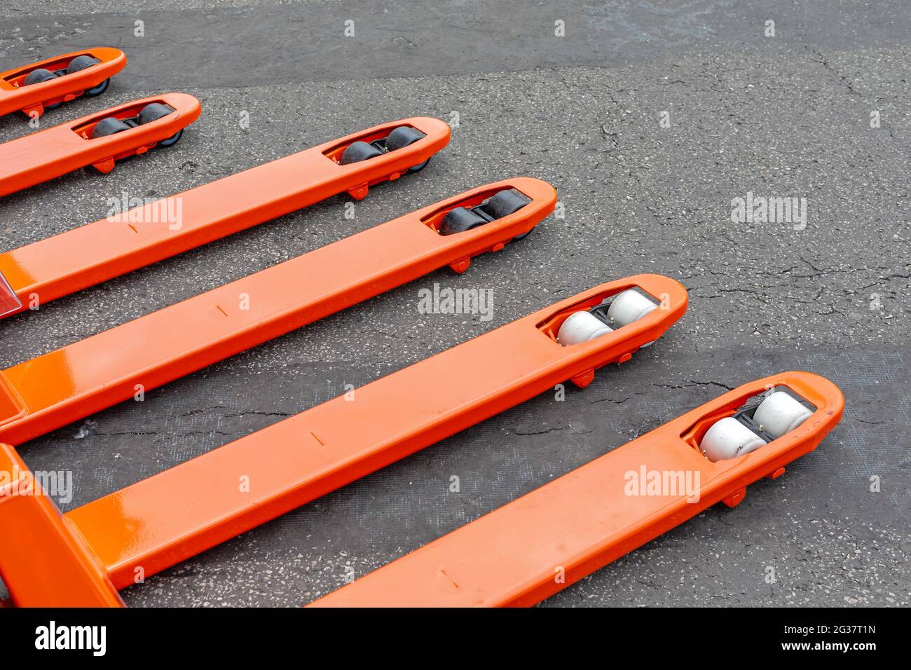 Long Orange Forks With Wheels at Pallet Jack Stock Photo - Alamy