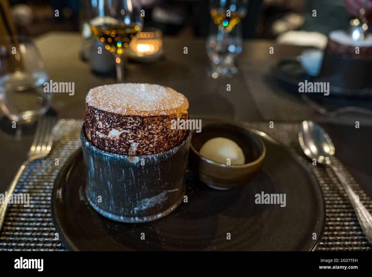Fine dining dessert: lemon soufflé with a spoonful of ice cream served ...