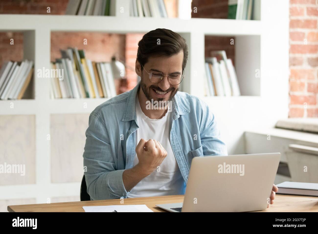Happy young male manager celebrating business or professional success ...